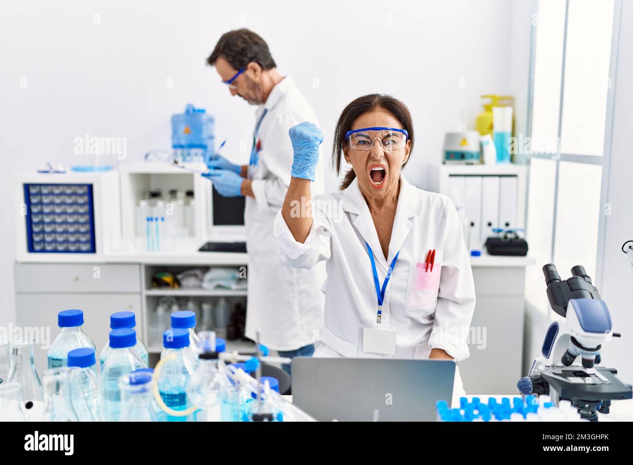 Middle age woman working at scientist laboratory annoyed and frustrated ...