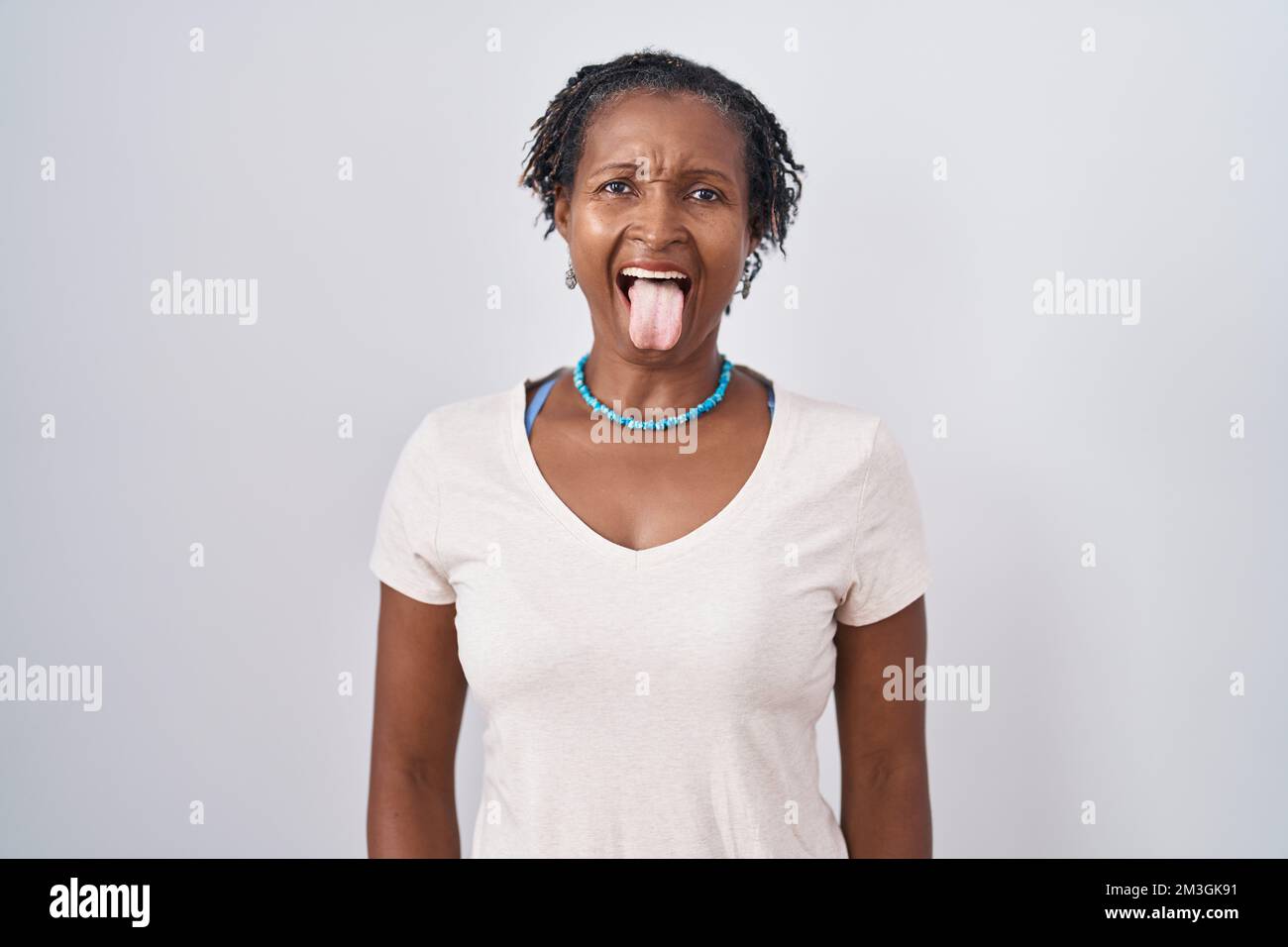 African woman with dreadlocks standing over white background sticking ...