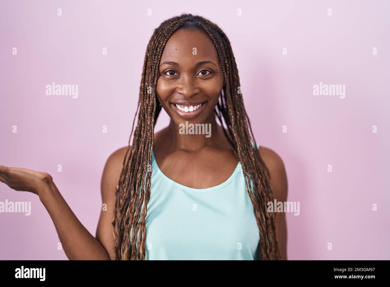 African american woman standing over pink background smiling cheerful ...