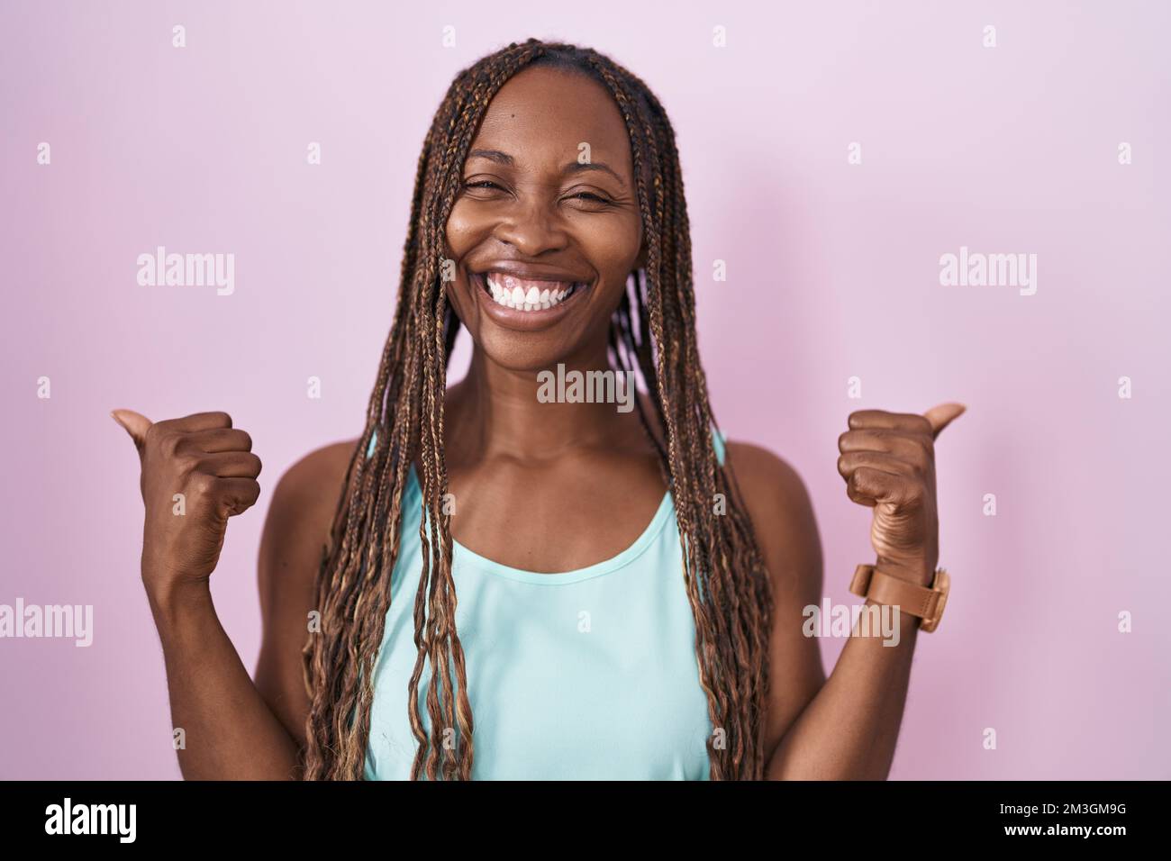 African american woman standing over pink background success sign doing ...