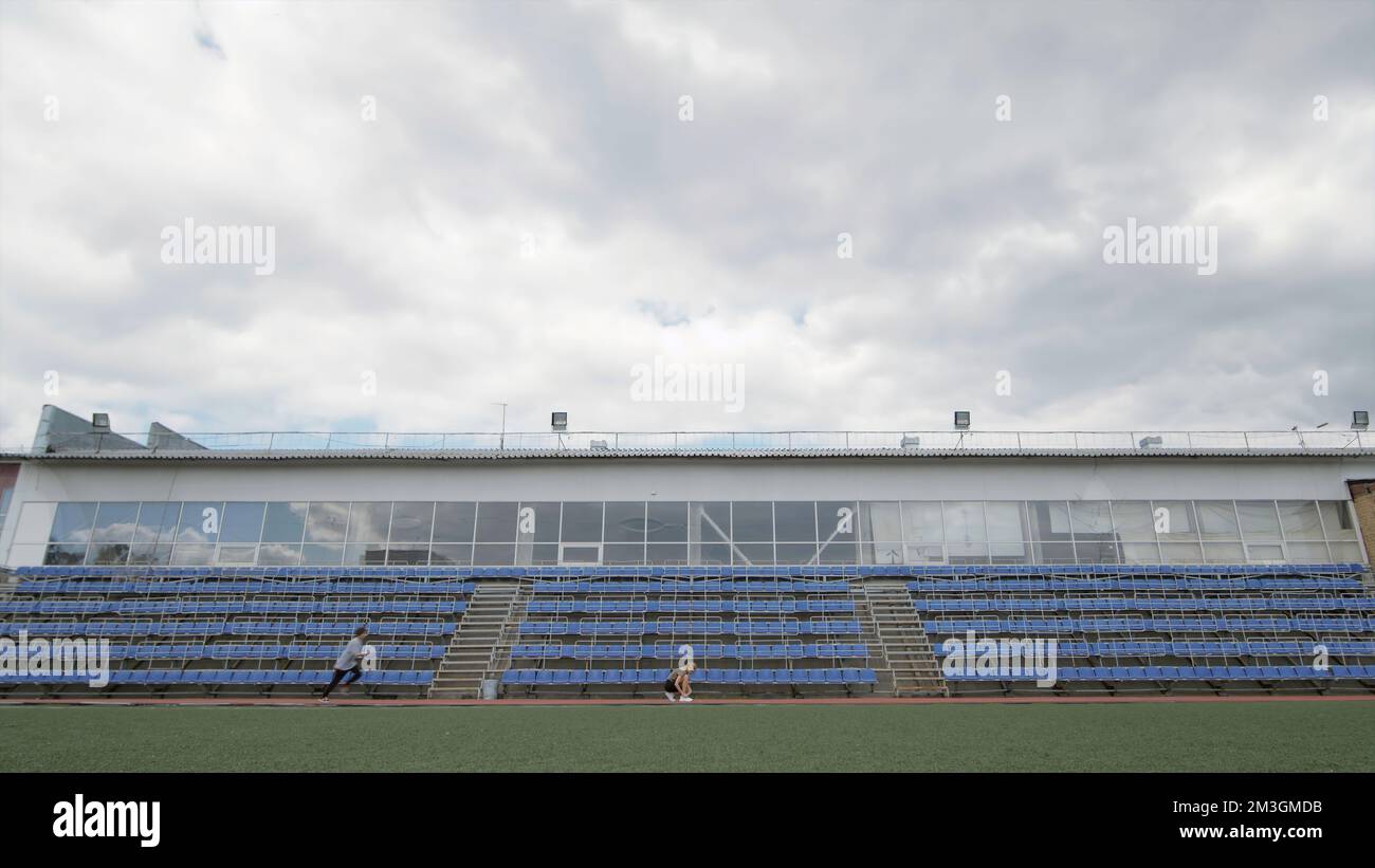 Runners train at stadium. Stock footage. View of sports stadium with ...