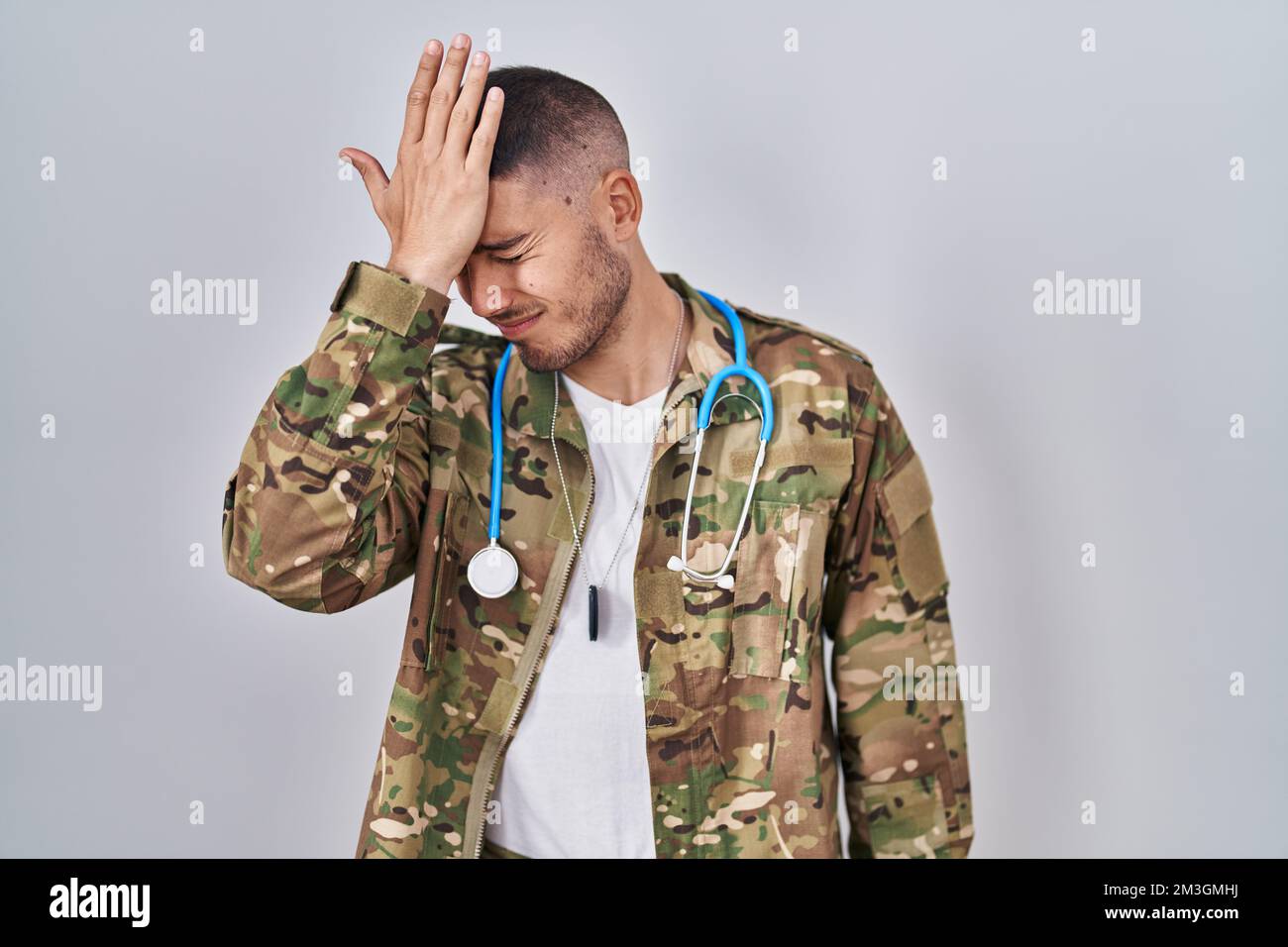 Young hispanic doctor wearing camouflage army uniform surprised with ...