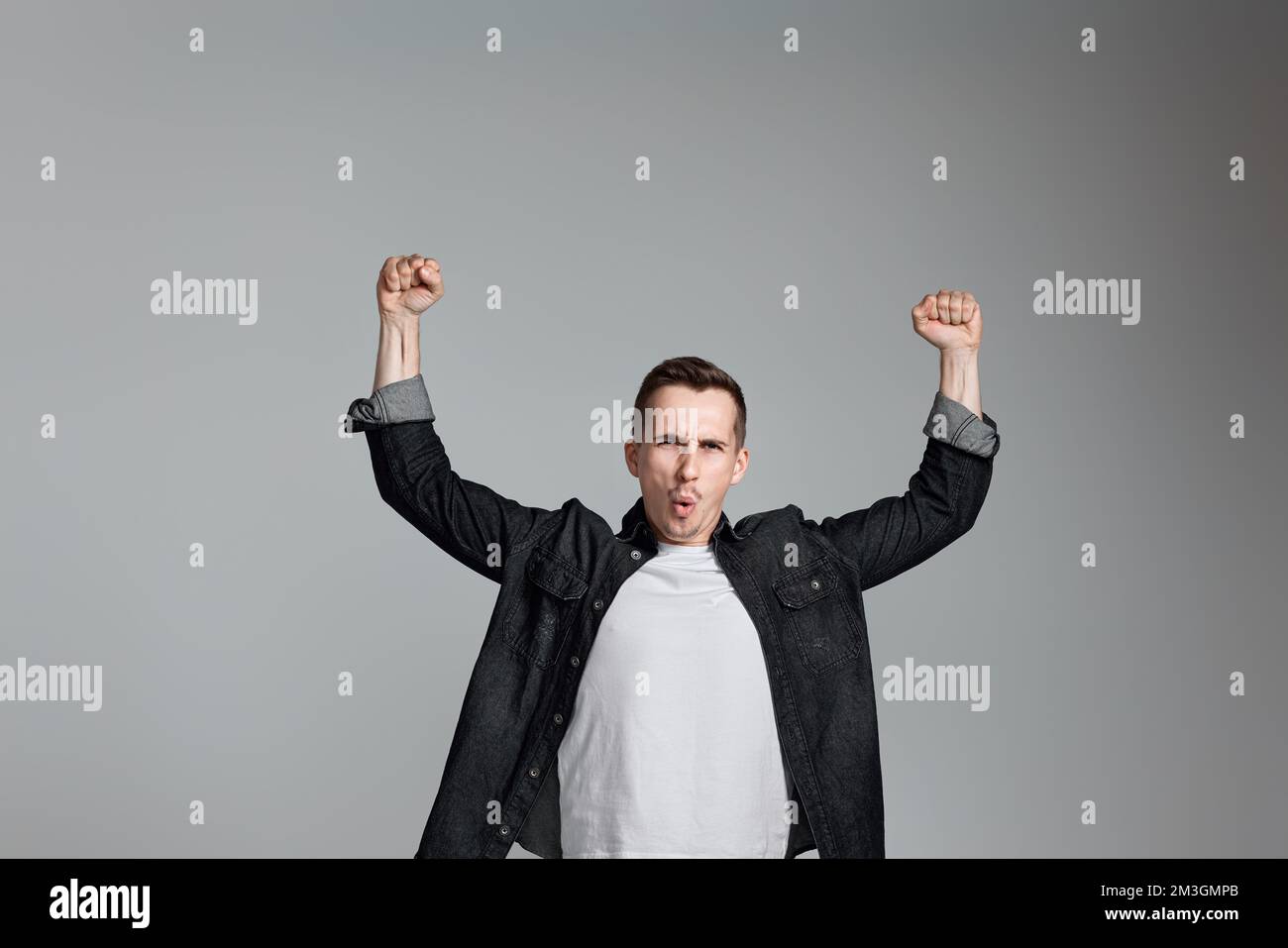 Man celebrating victory raising hands hi-res stock photography and ...