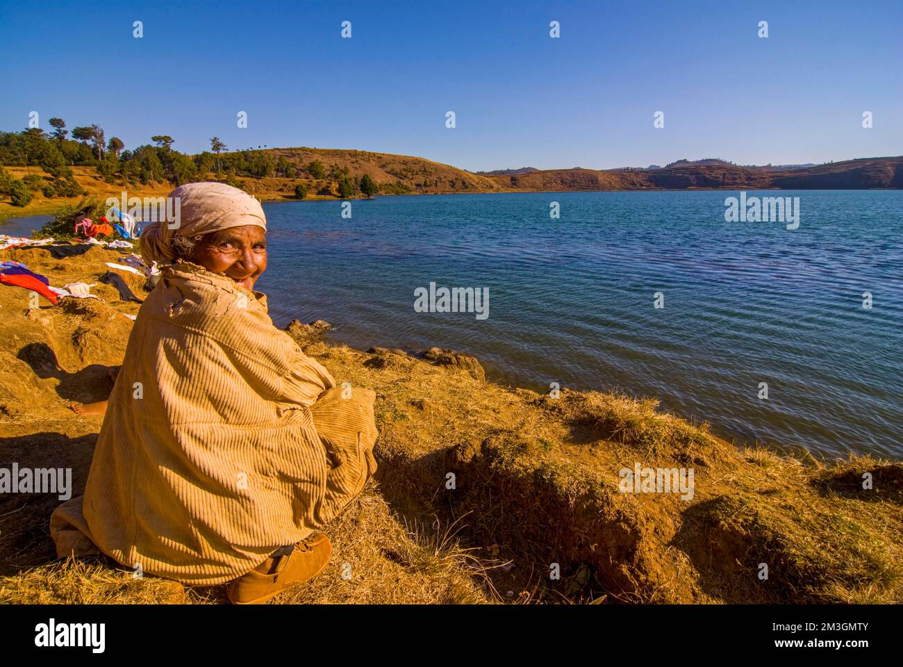 Old woman sitting on Lac Andraikiba, Antsirabe, Madagascar, Indian ...