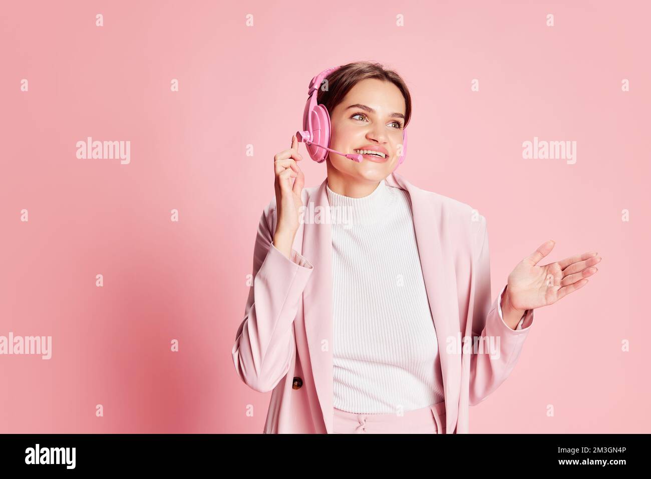 Portrait of young beautiful girl in a suit and headphones, working over ...