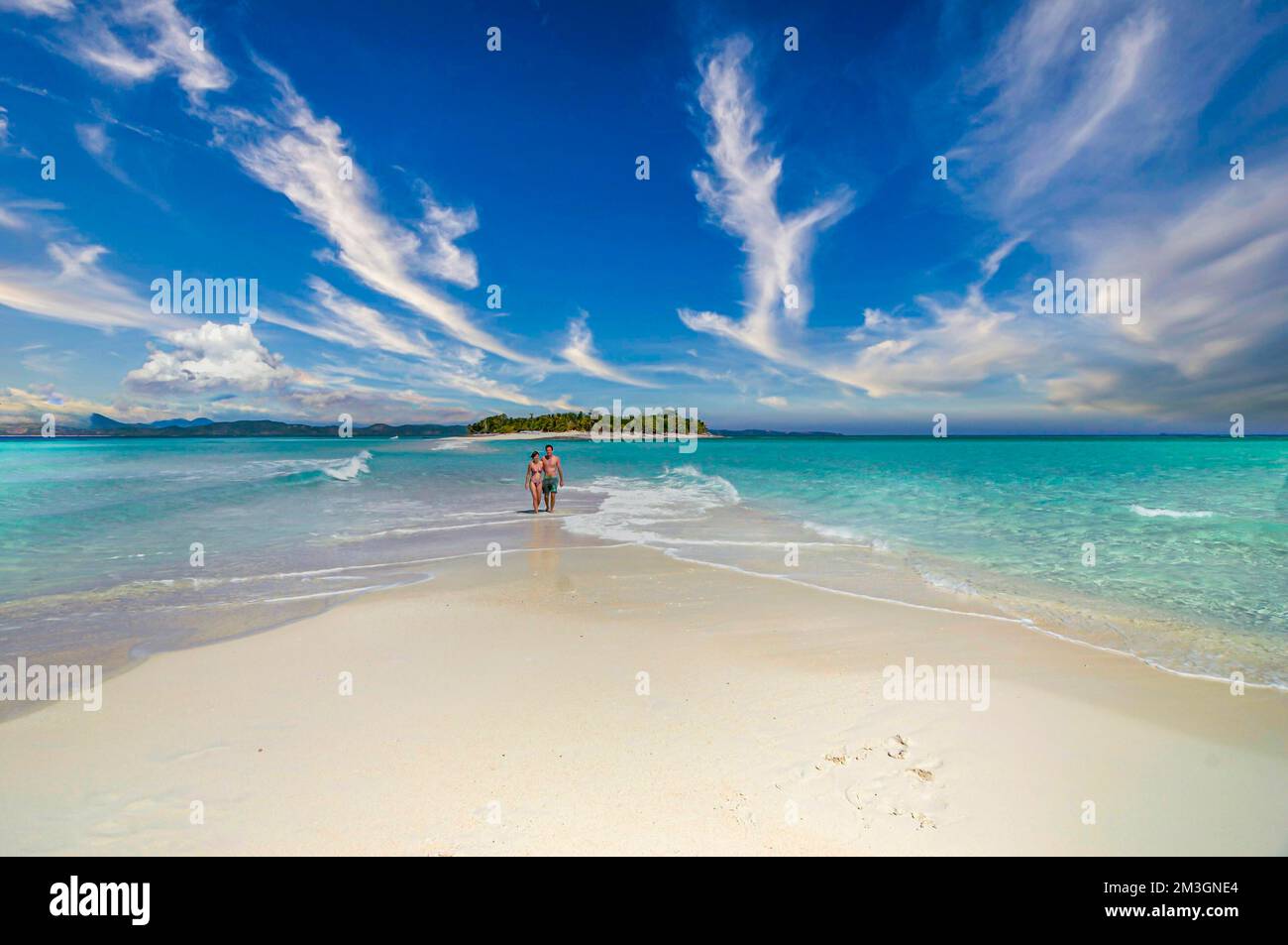Couple on a beautiful white sand beach, Nosy Iranja near Nosy Be ...