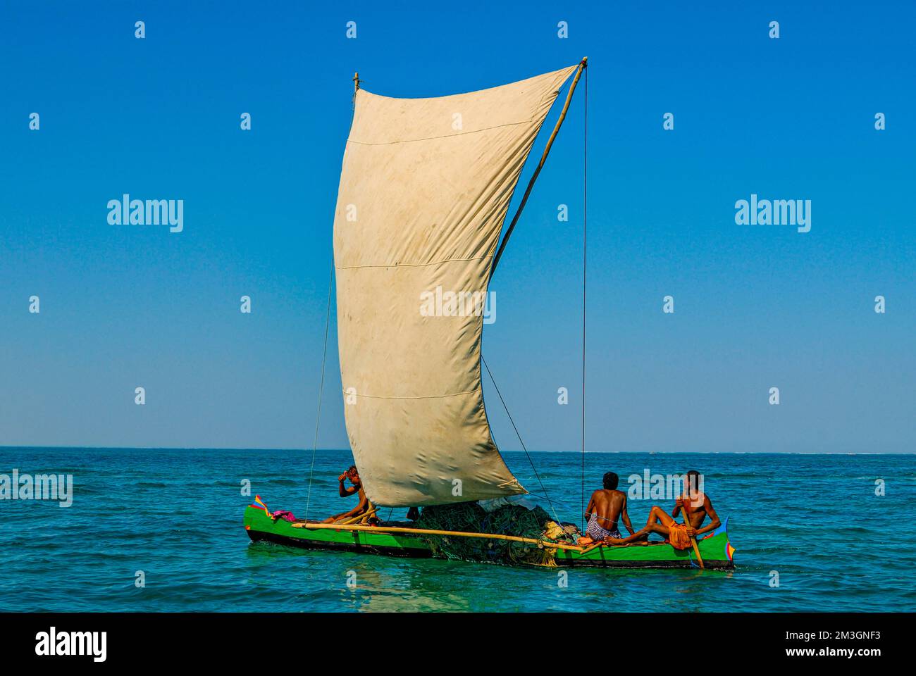Traditional sailing boat and rowing boat in the turquoise water of the ...
