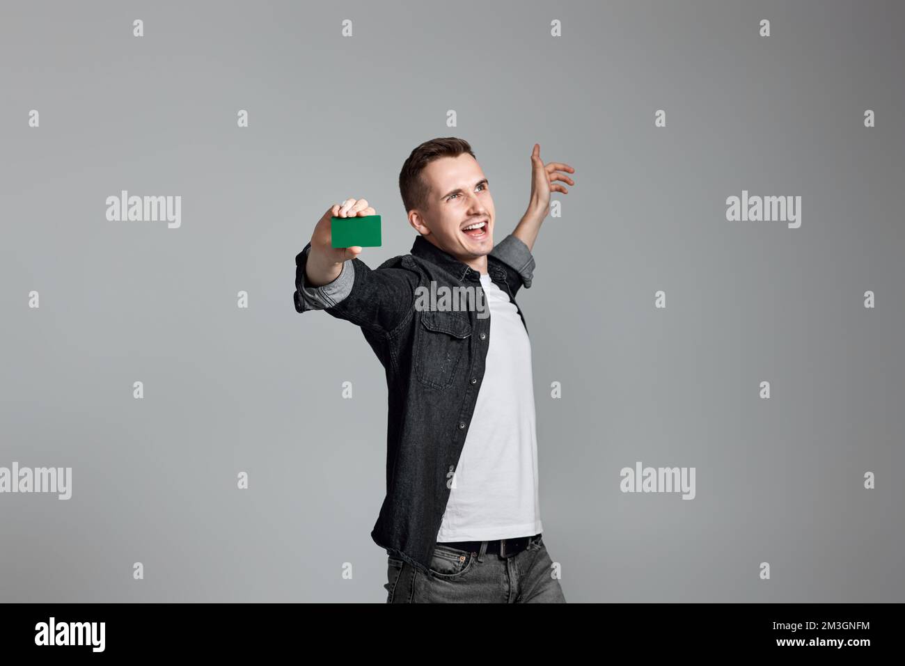 Young black man holding card hi-res stock photography and images - Alamy