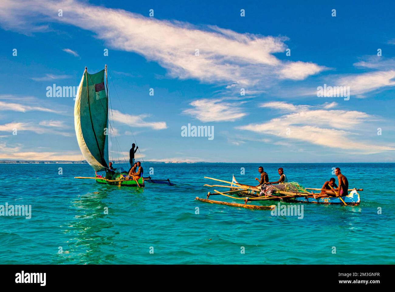 Traditional sailing boat and rowing boat with a dead (manta) ray in the ...