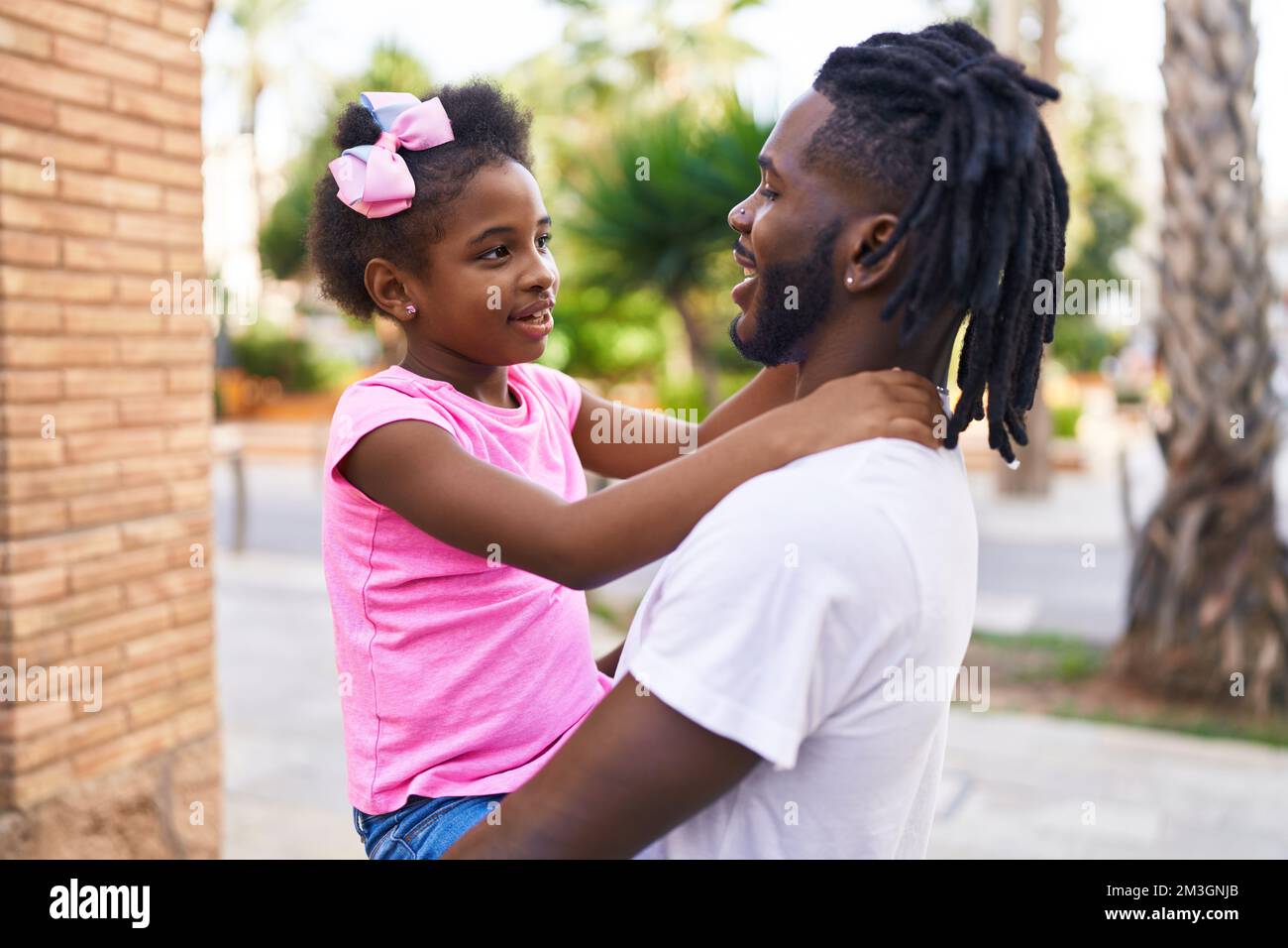 Father and daughter smiling confident hugging each other at street Stock Photo - Alamy