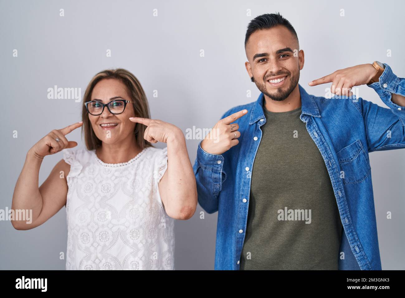 Hispanic mother and son standing together smiling cheerful showing and ...