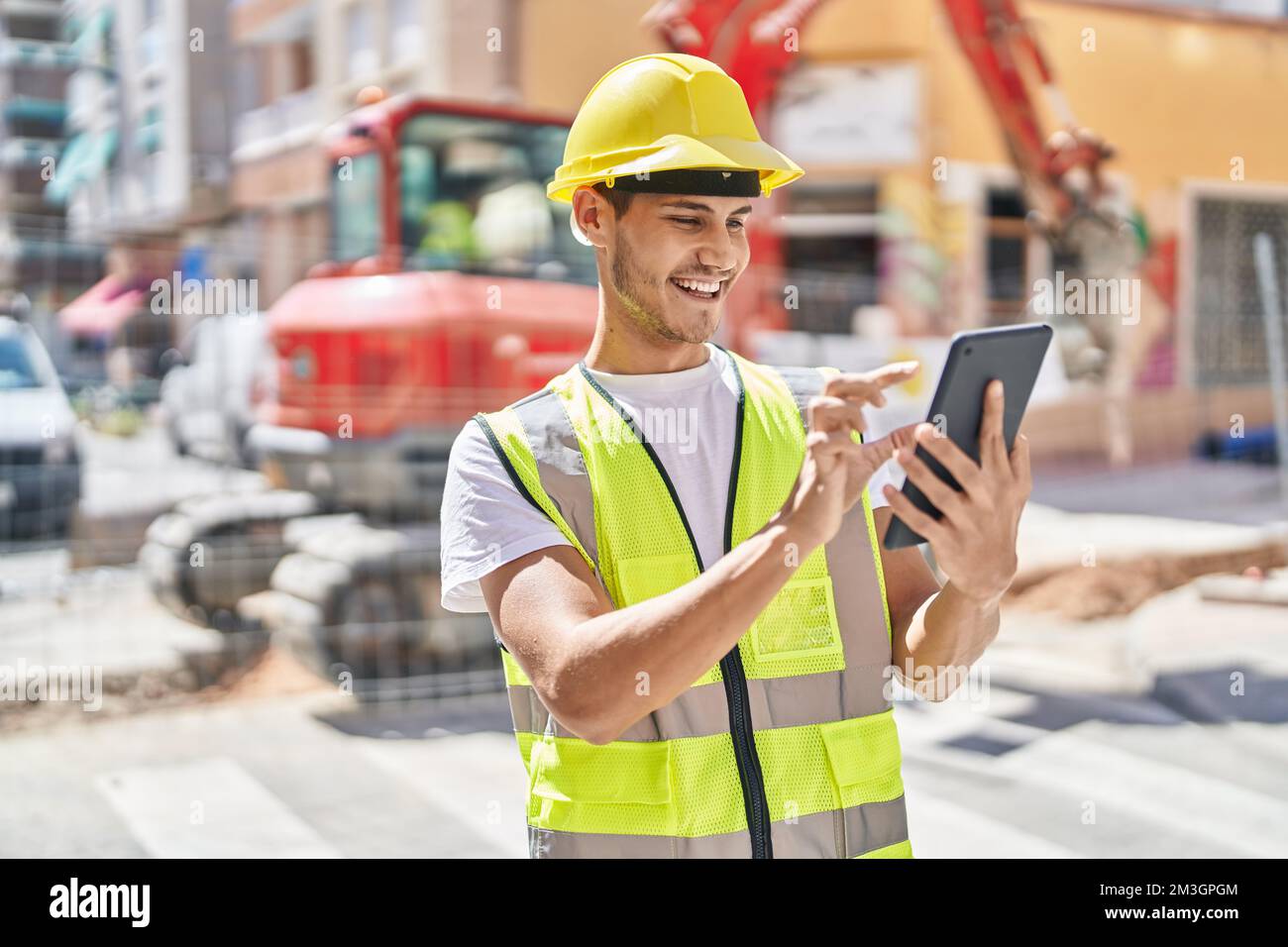Young hispanic man architect using touchpad at park Stock Photo - Alamy
