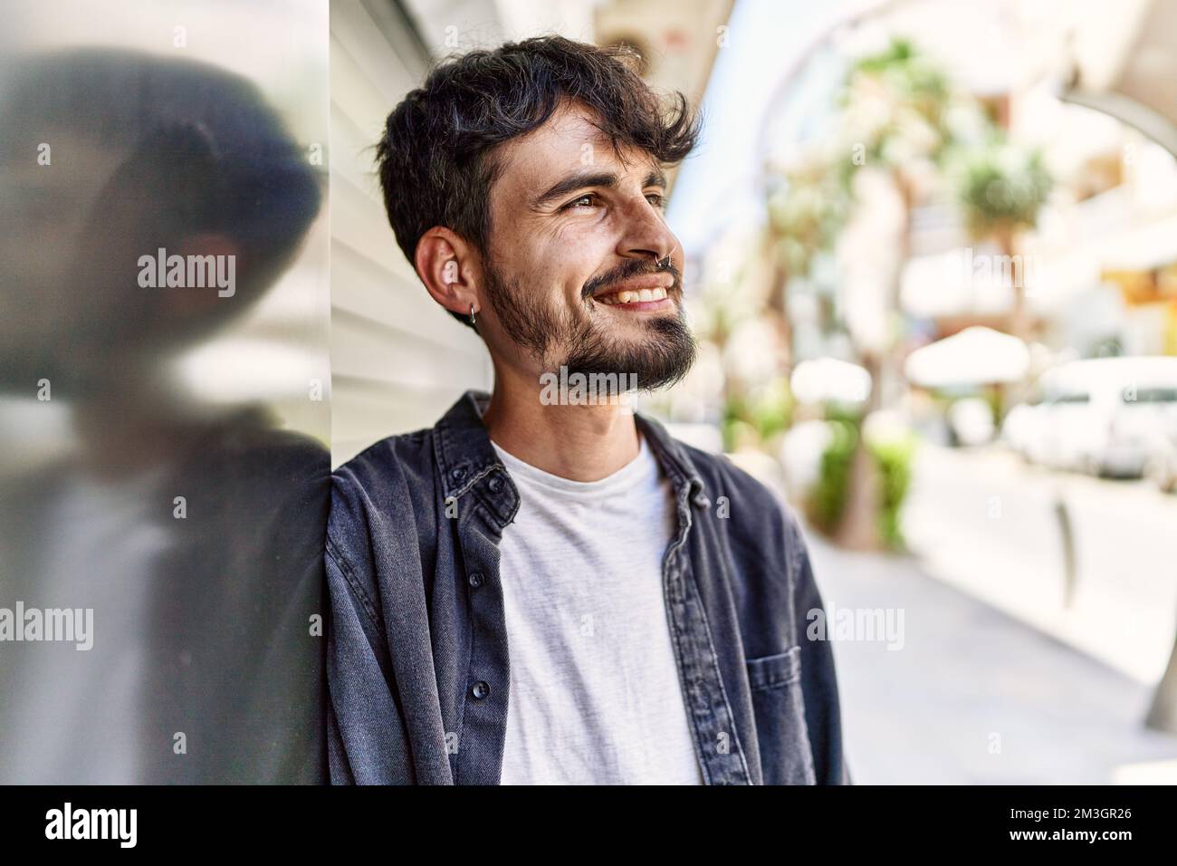 Young hispanic man smiling happy standing at the city Stock Photo - Alamy