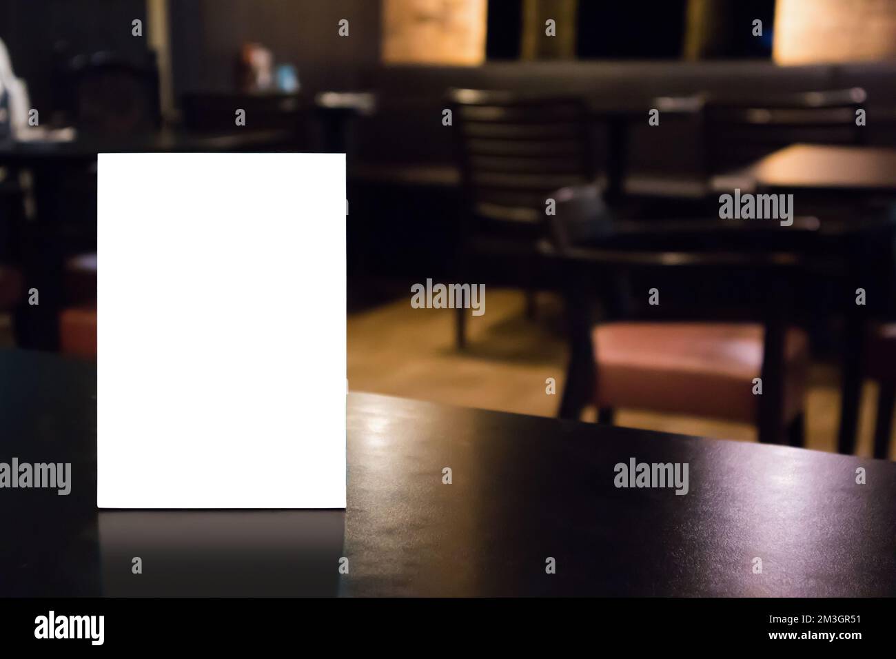 Mockup empty white label menu frame on table with cafe restaurant ...