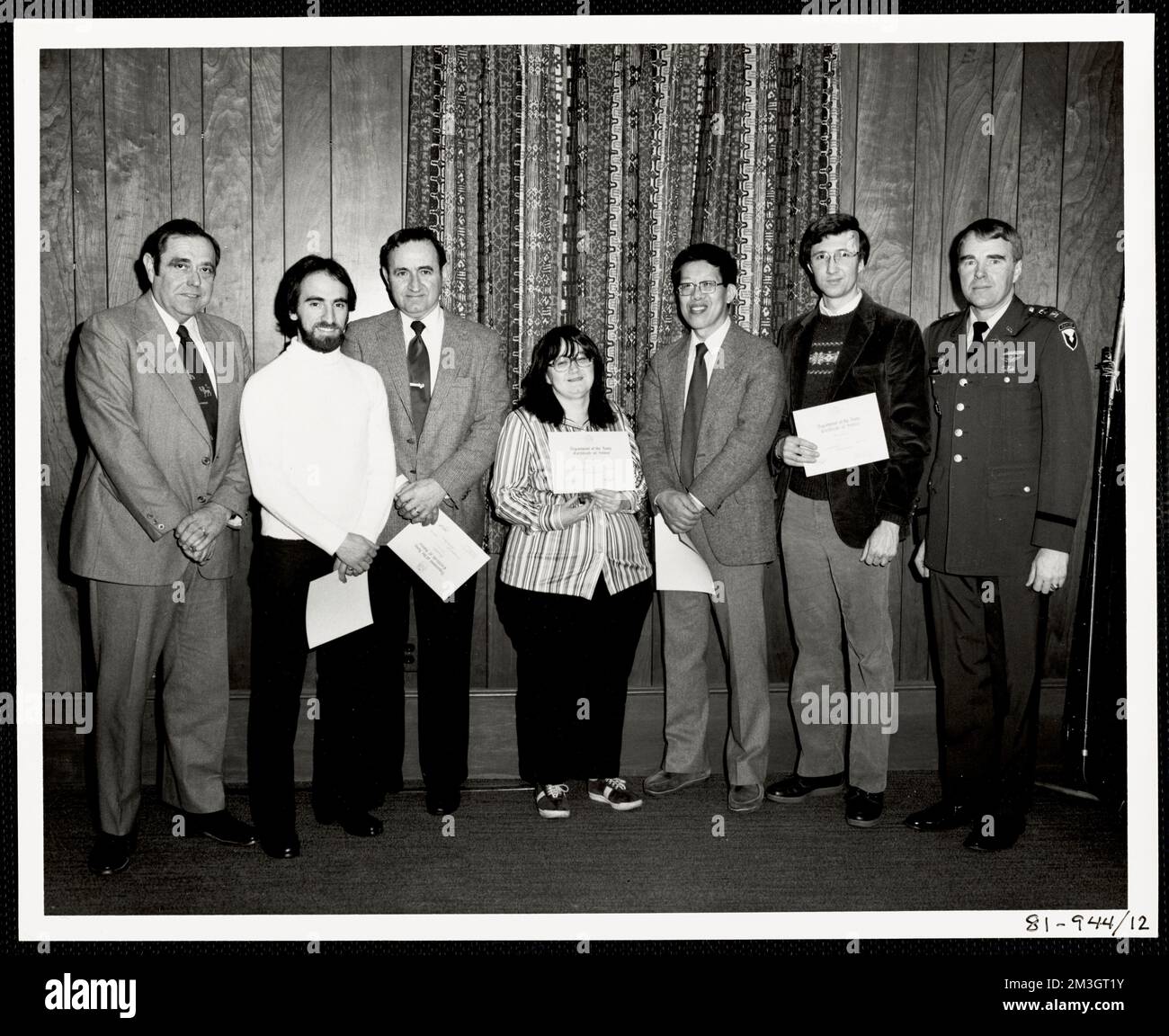Men and woman receiving Department of the Army Certificate of Service ...
