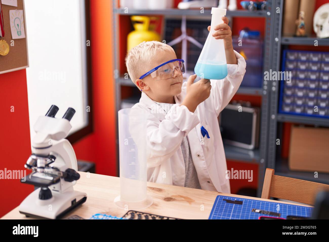 Adorable toddler student holding test tube at classroom Stock Photo - Alamy