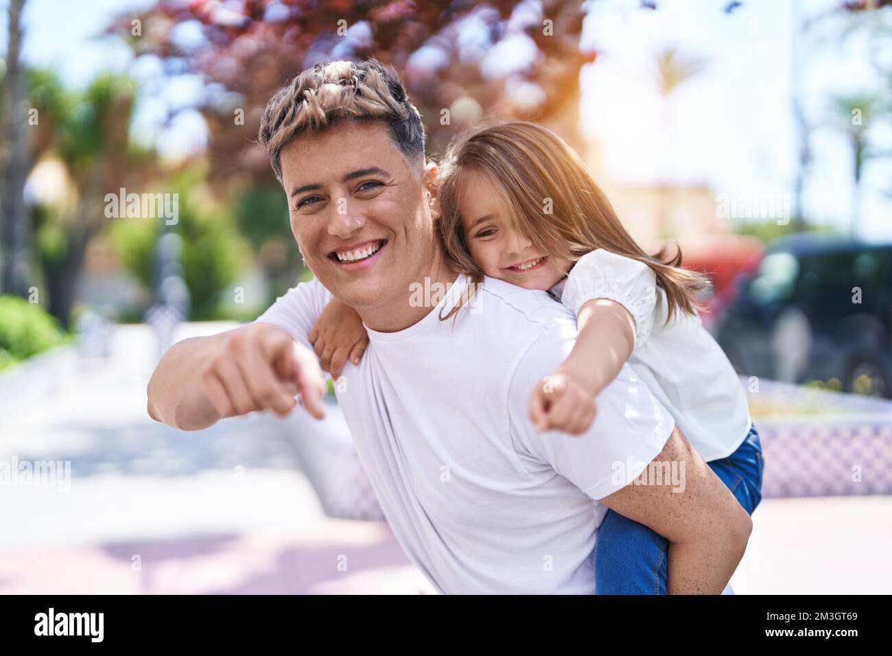 Father and daughter smiling confident hugging each other holding on back at park Stock Photo - Alamy