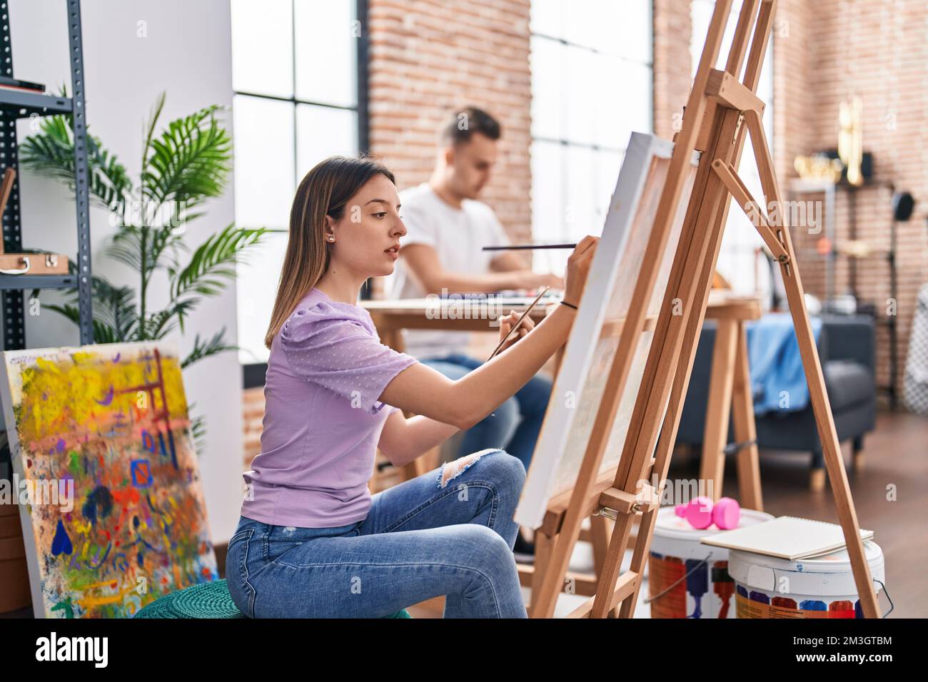 Man and woman artists couple drawing at art studio Stock Photo - Alamy