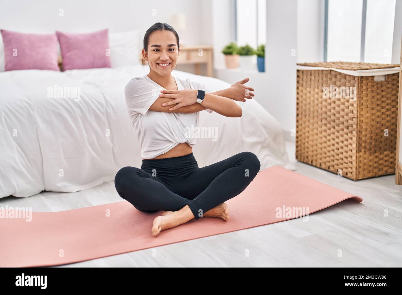 Young hispanic woman smiling confident stretching arms at bedroom Stock ...
