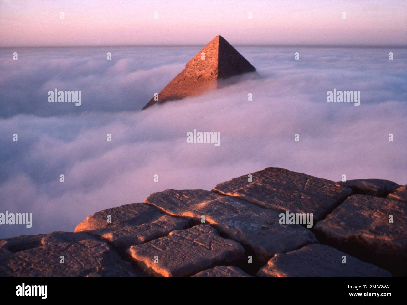 Pyramid top sticking out of the clouds Stock Photo - Alamy