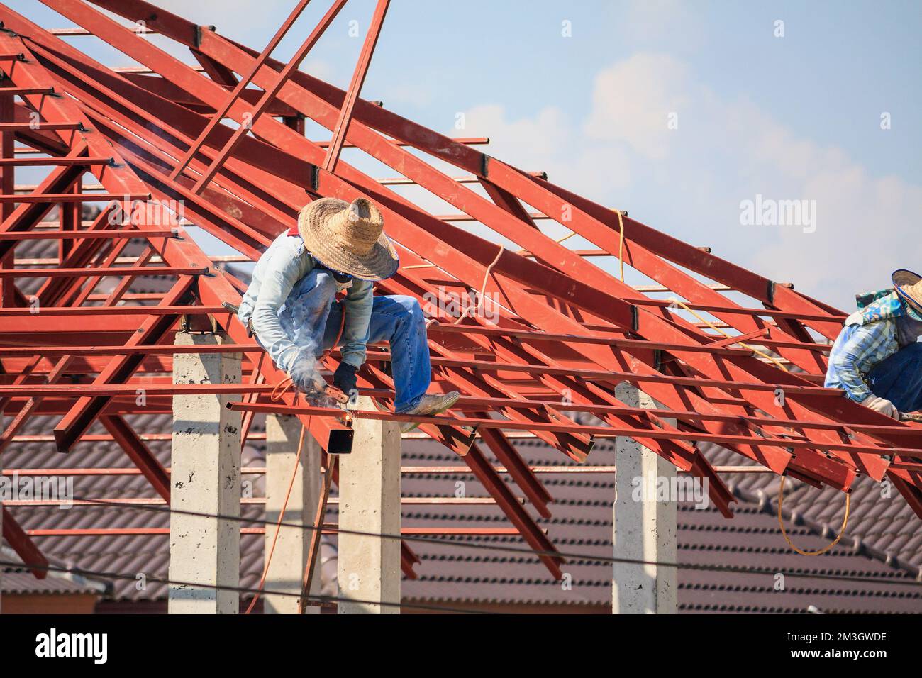 Construction welder workers installing steel frame structure of the ...