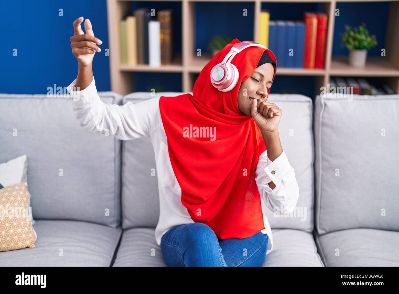 Young beautiful woman listening to music singing song at home Stock ...