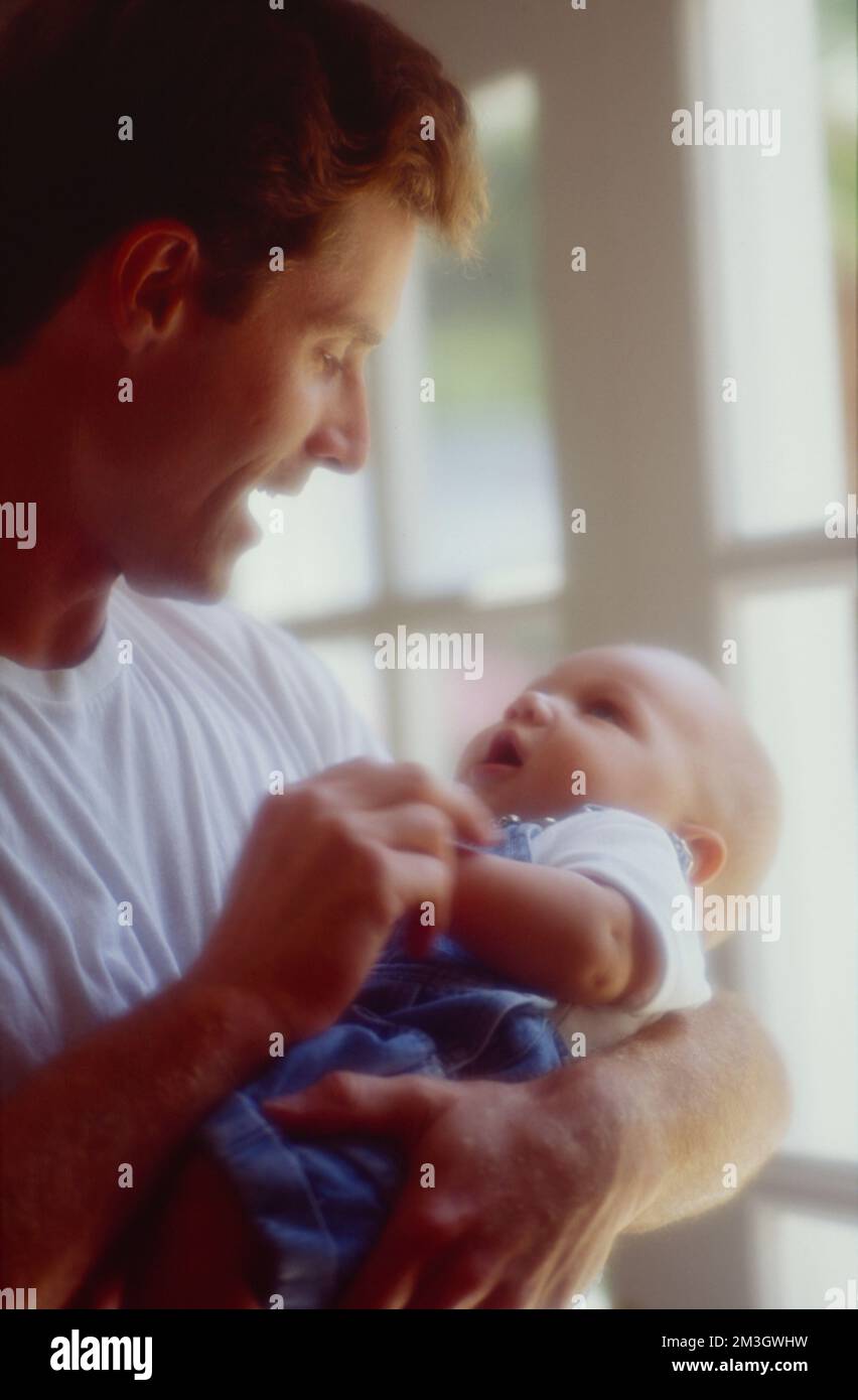 Father touching baby hi-res stock photography and images - Alamy