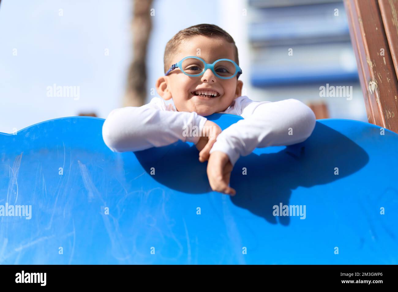 Adorable hispanic toddler smiling confident playing on slide at park playground Stock Photo - Alamy
