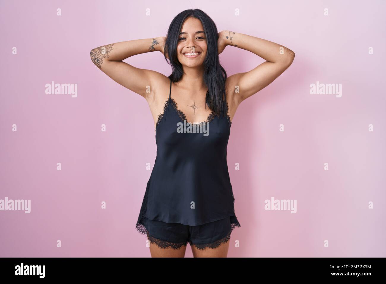 Brunette Woman Wearing Black Pajama Relaxing And Stretching Arms And