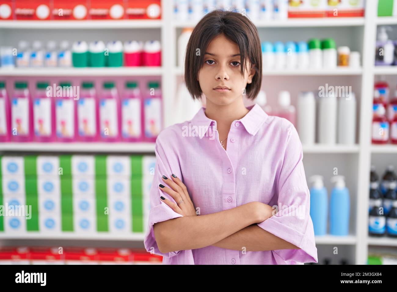 Young girl at pharmacy drugstore skeptic and nervous, disapproving ...