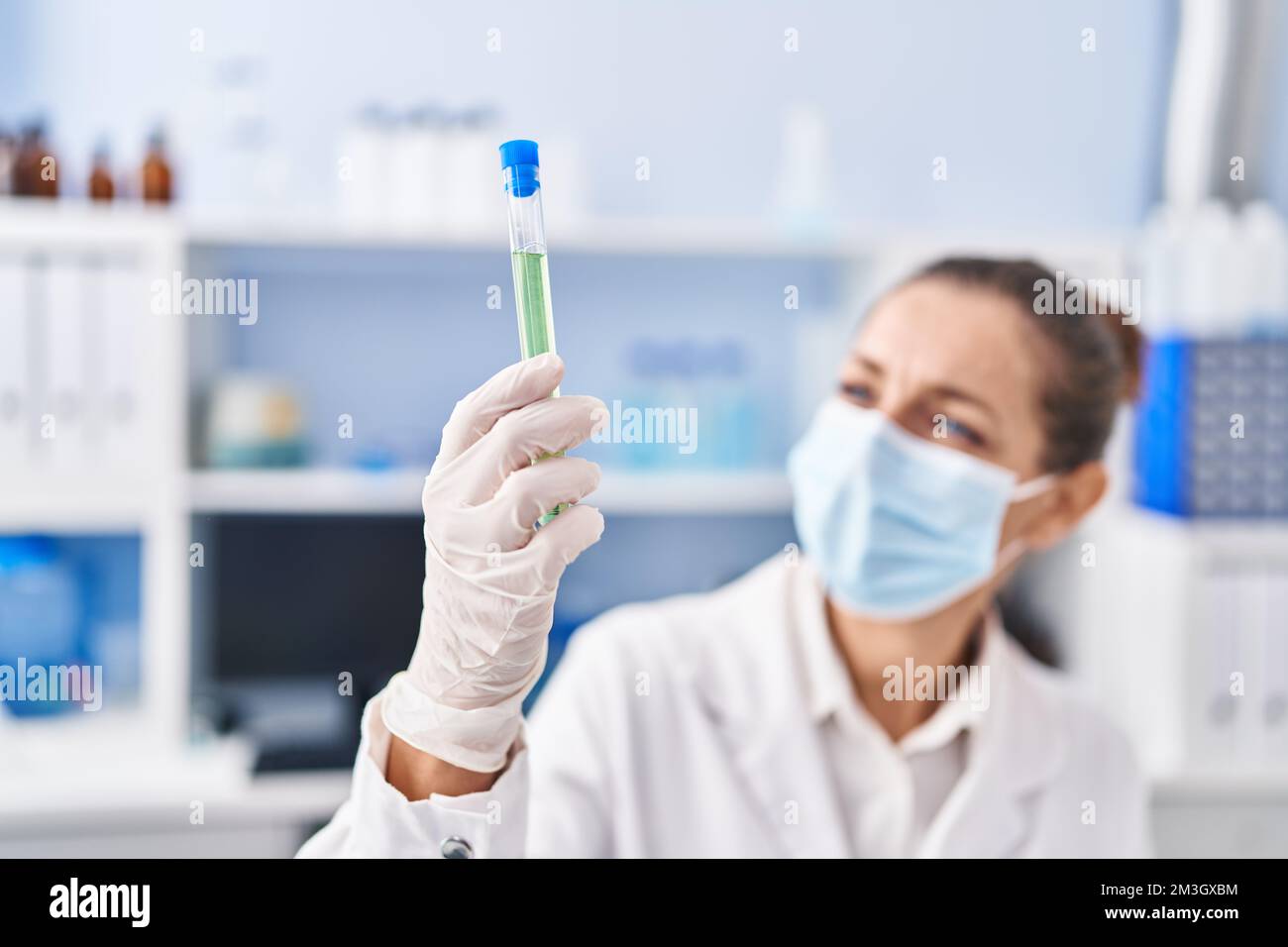 Young woman scientist holding test tube at laboratory Stock Photo - Alamy