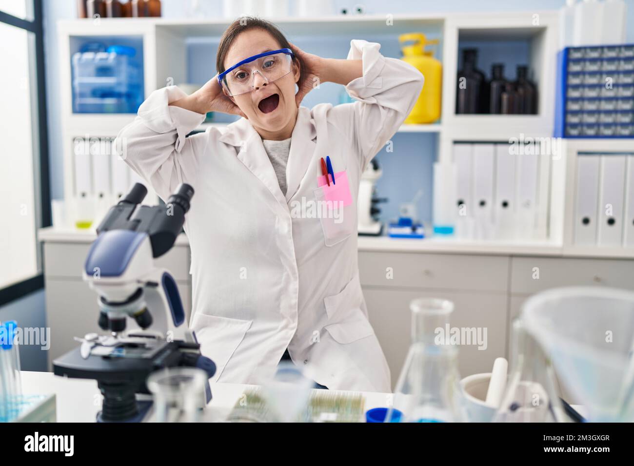 Hispanic girl with down syndrome working at scientist laboratory crazy ...