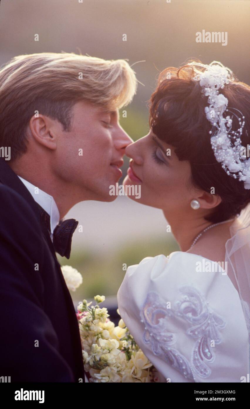 Young newly married couple at wedding kissing Stock Photo - Alamy