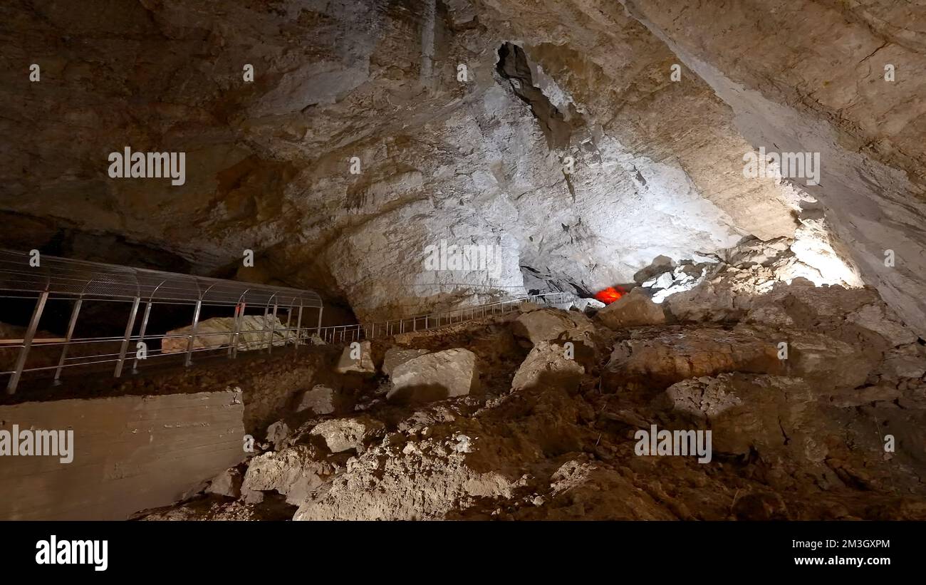 Stone walls of cave with illumination. Action. Large closed cave with ...