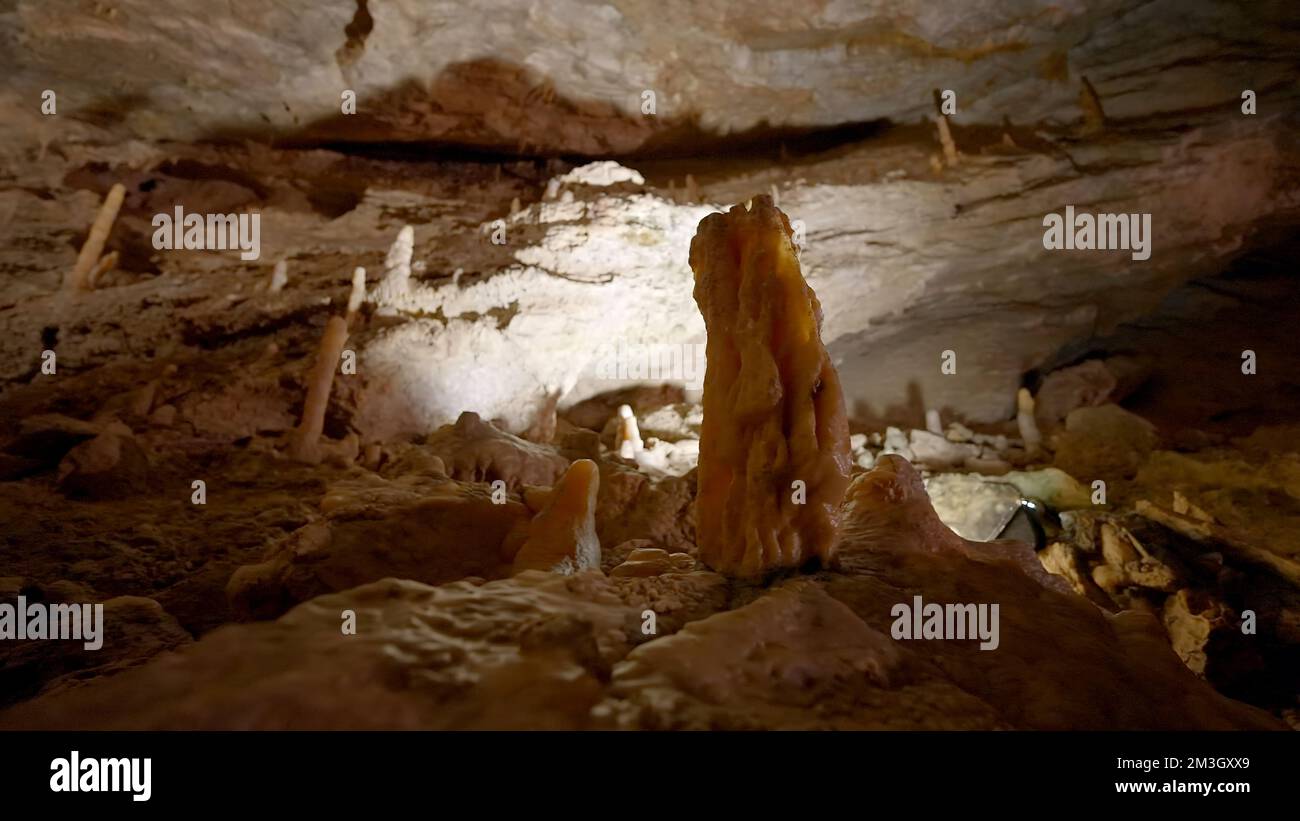 Stone walls of cave with illumination. Action. Large closed cave with ...