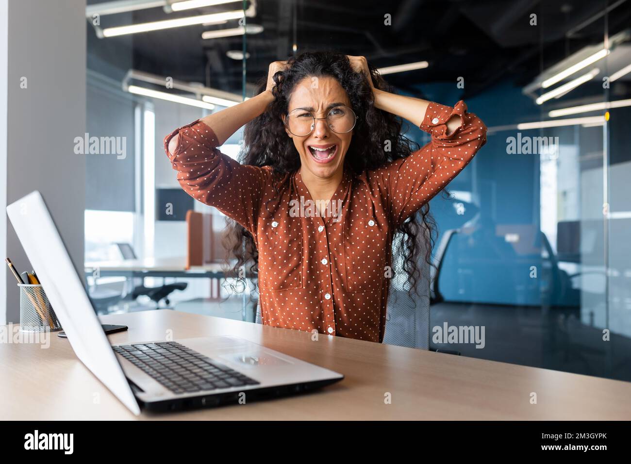 Angry businesswoman yelling at camera, latin american woman holding her ...