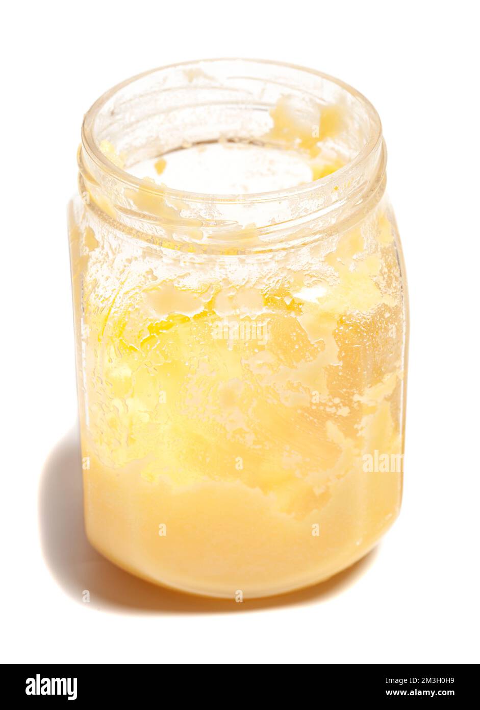 Ghee in jar isolated on white background Stock Photo - Alamy