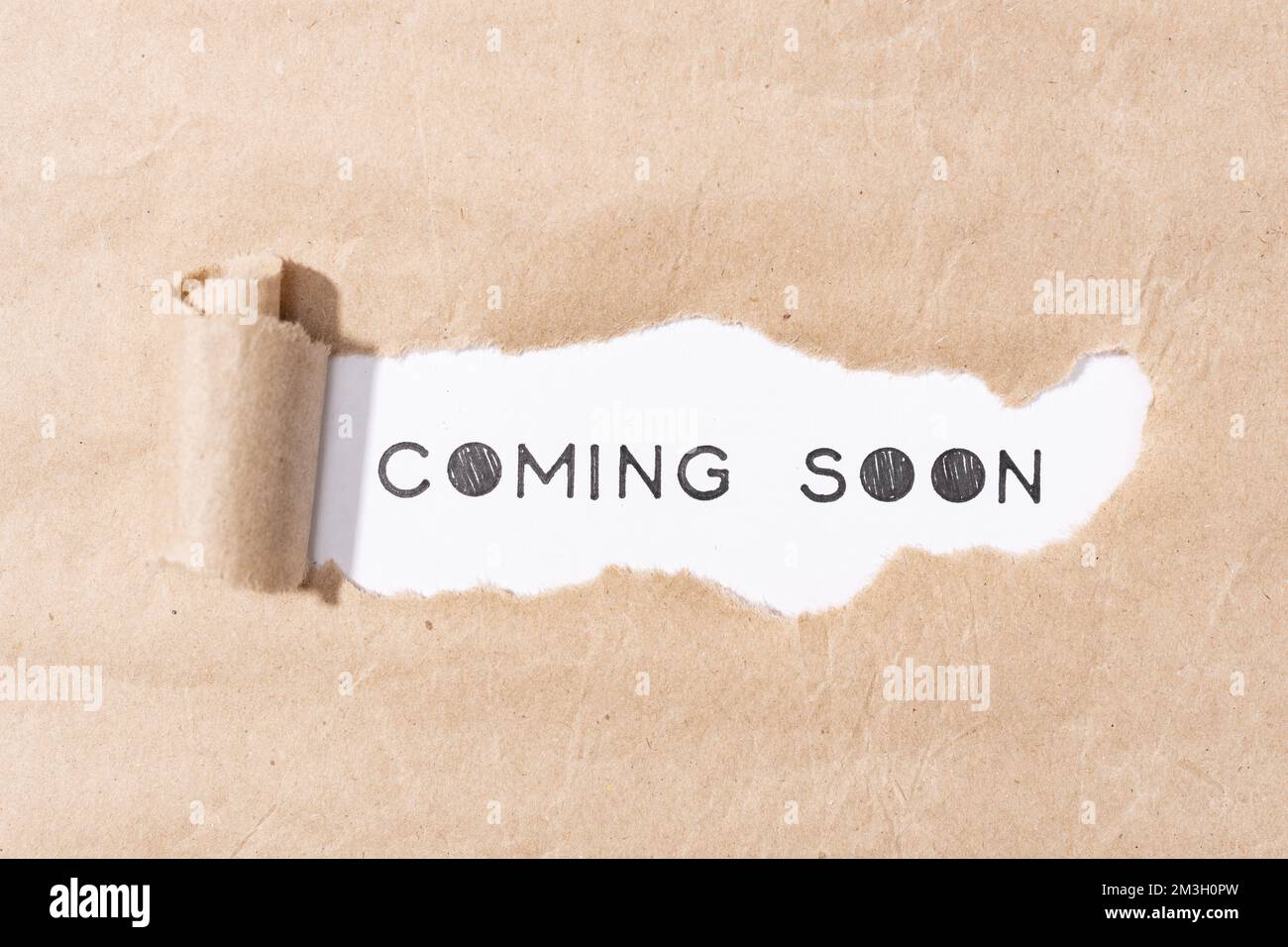 Coming soon message on torn paper. White and brown paper Stock Photo ...