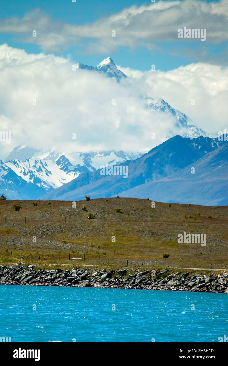 A vertical shot of clouds over Mount Cook with a hydro canal in the ...