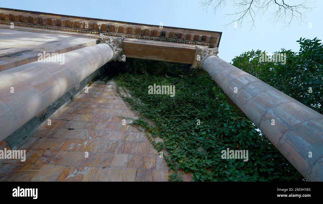 A large stone arch . Action . A huge monument with green plants growing ...