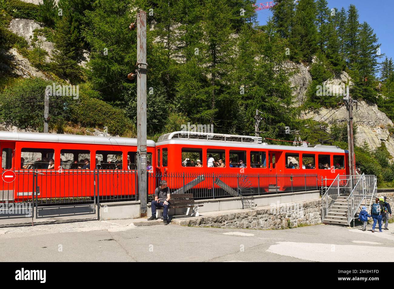 A red tourist train on the rack railway in the station of Montenvers at ...