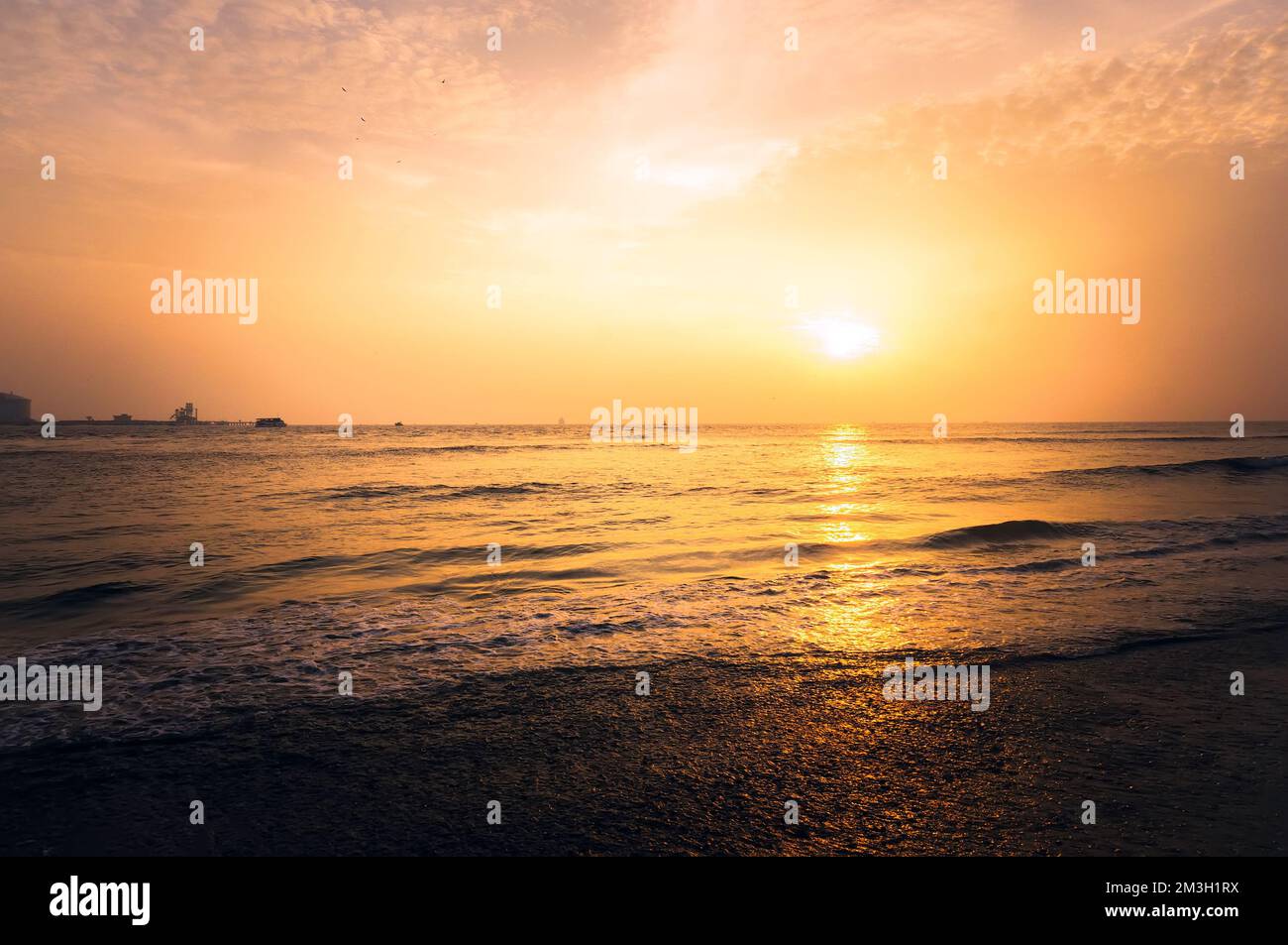 Orange and yellow glowing sunset in India, with a turquoise sea Stock ...