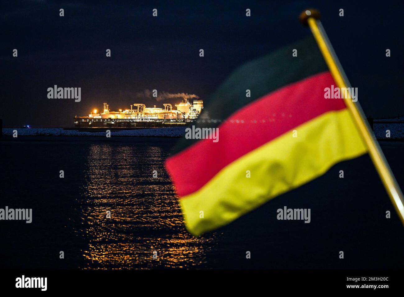 Hooksiel, Germany. 15th Dec, 2022. A German flag waves in front of the ...