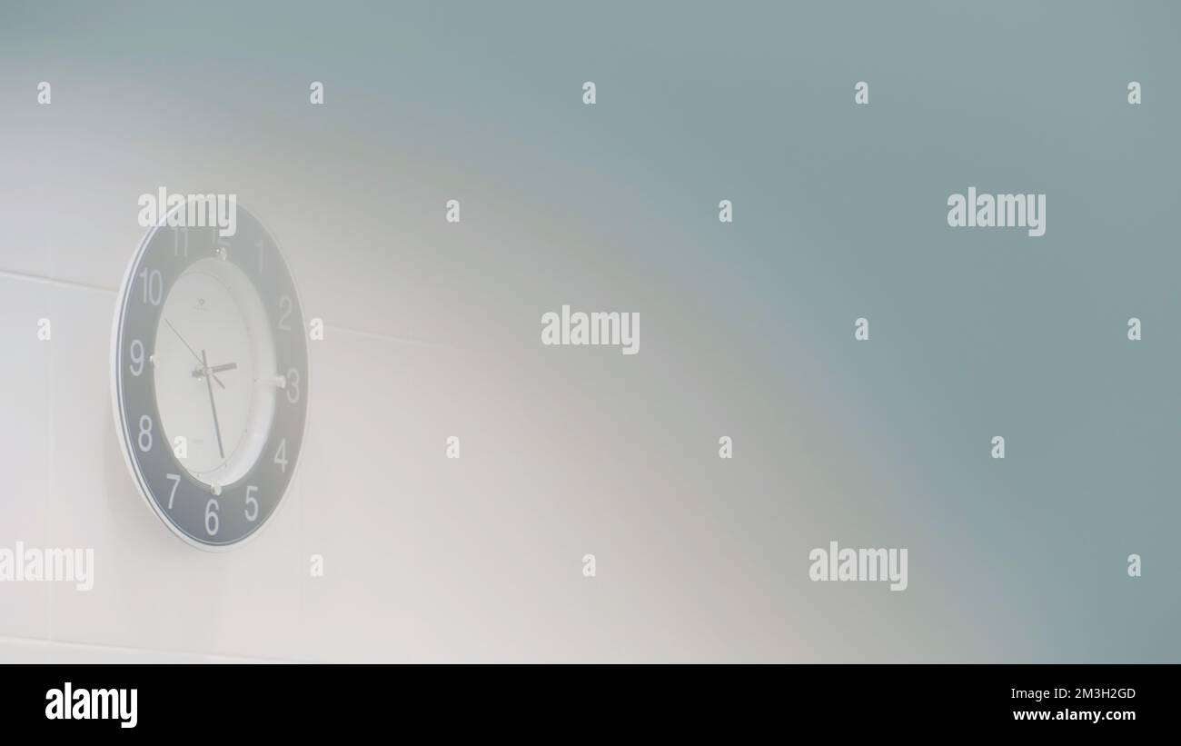 Round wall clock. Action.A white light wall with a small round clock ...