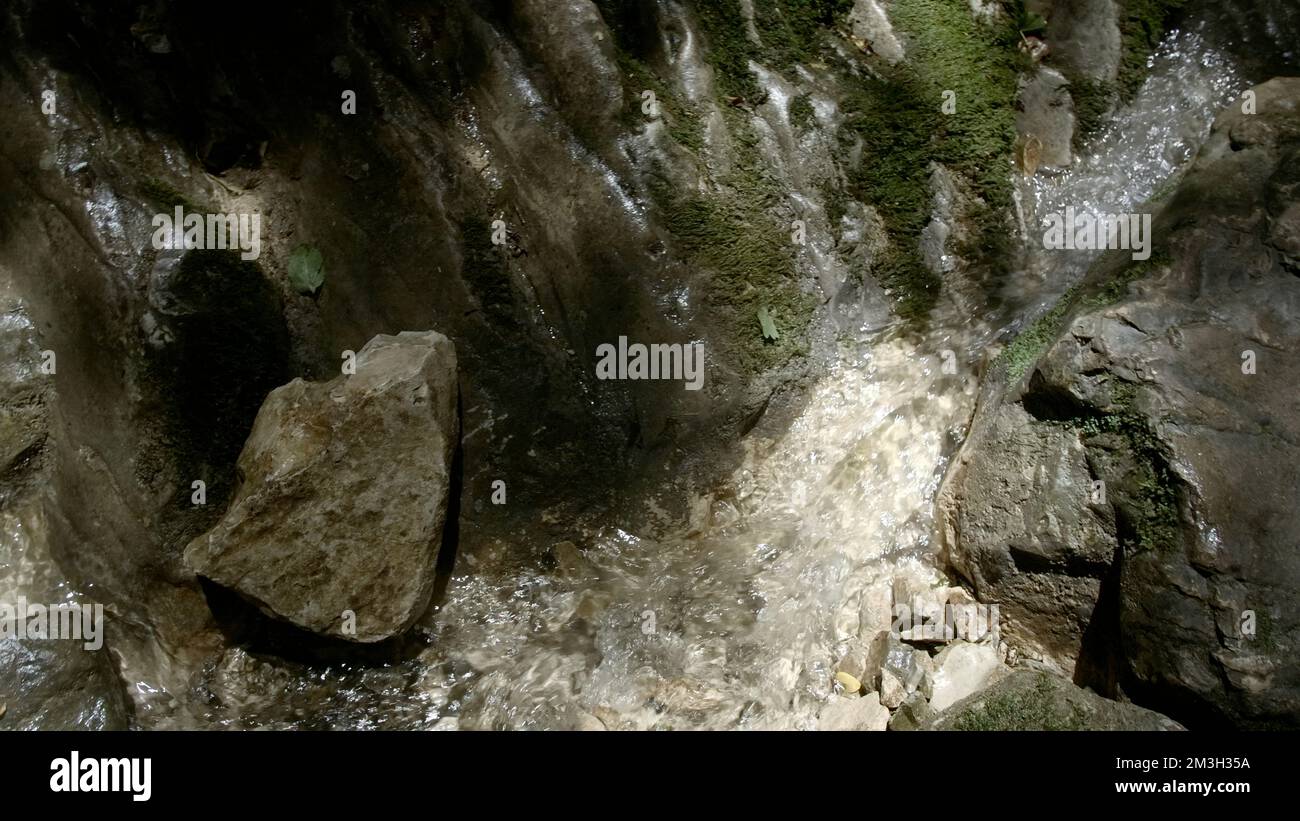 A large stream of water in the mountains. Creative.A long stream ...