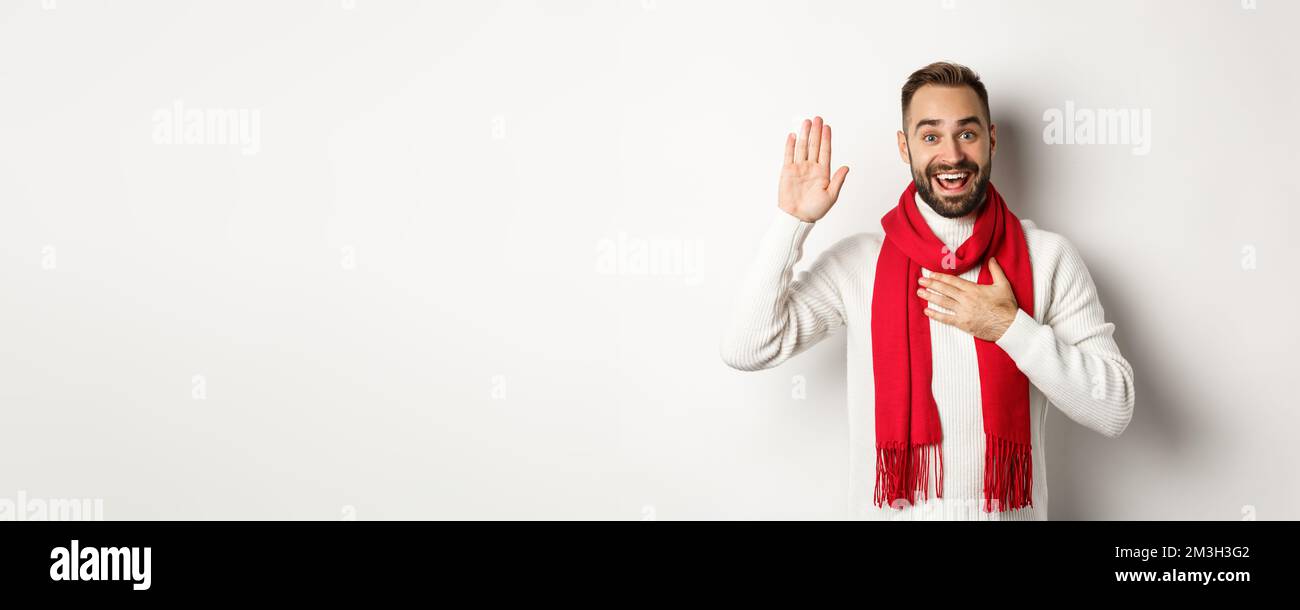 Attractive caucasian man telling truth, holding hand on heart and ...