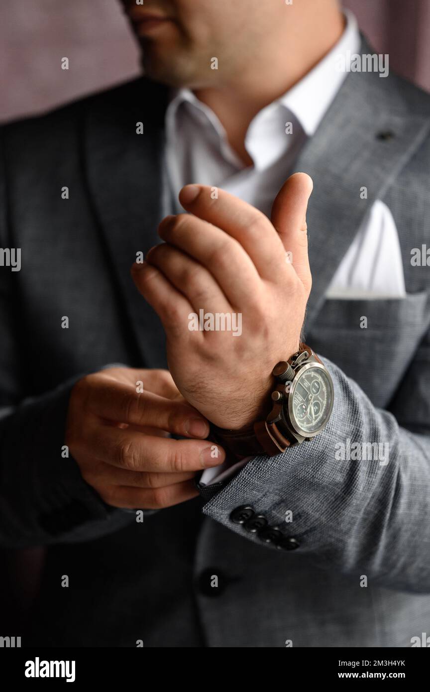 Man puts a watch hi-res stock photography and images - Alamy