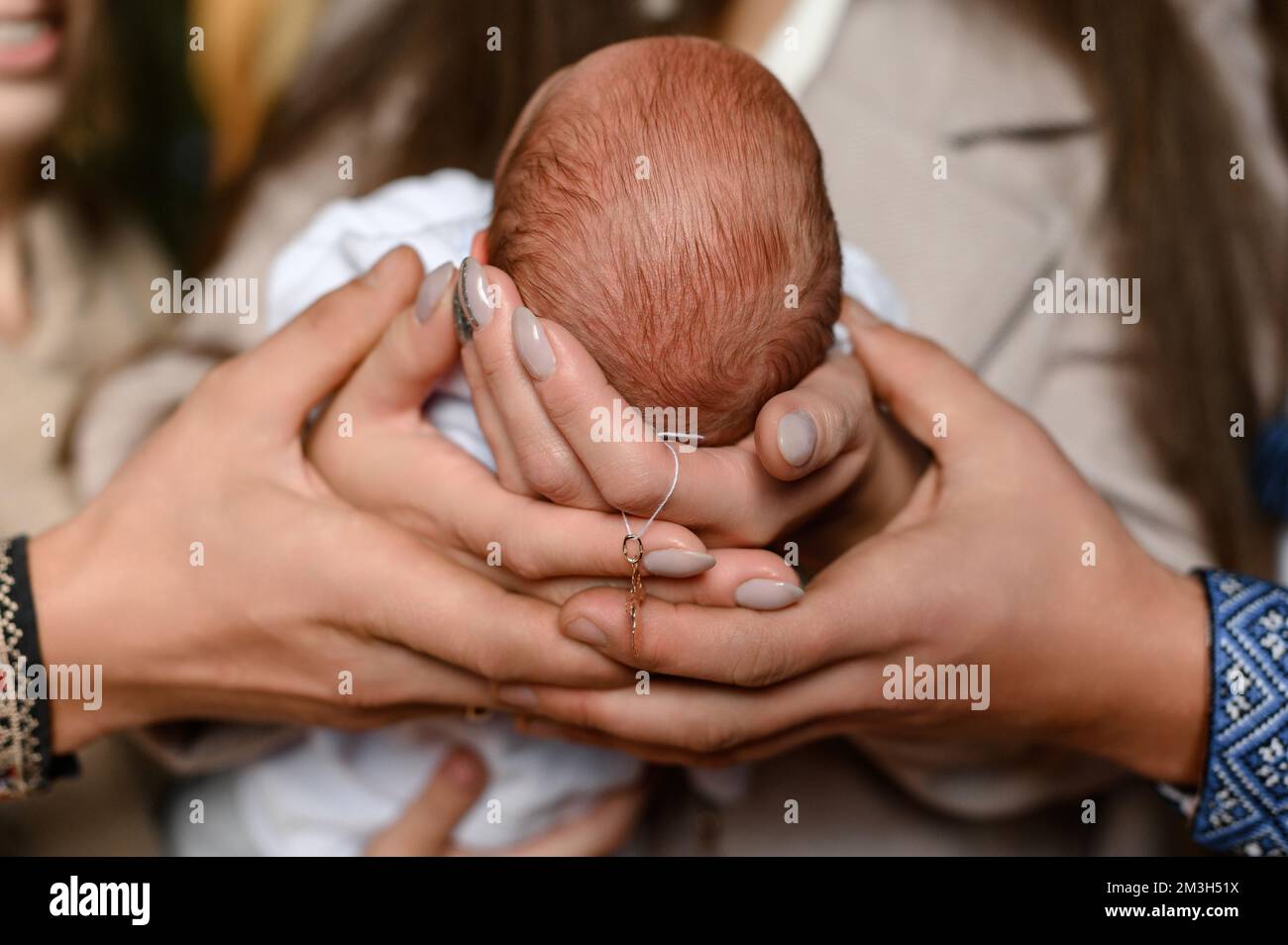 The sacrament of the baptism of a child in the church, the parents hold ...