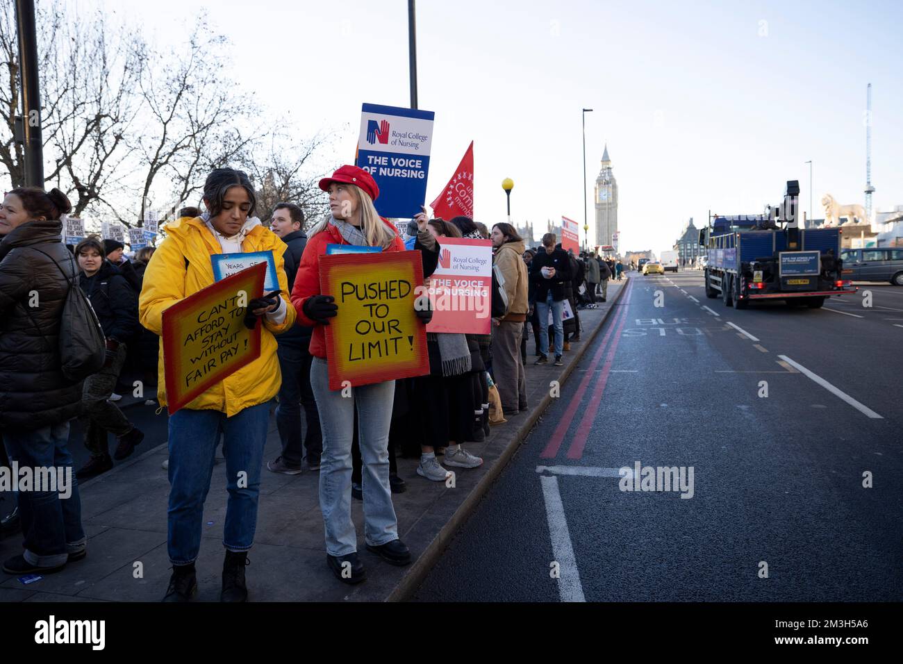 Nurses on strike are seen holding placards during the rally outside the ...