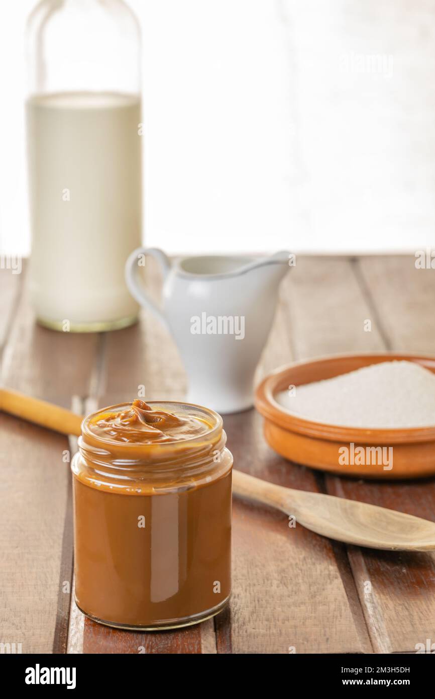 Jar of Dulce de leche, traditional sweet from Argentina on wooden table ...